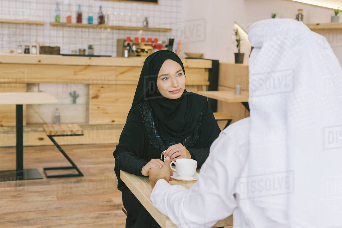muslim couple having date in cafe and drinking coffee - Stock Photo ...