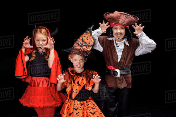 Spooky children in Halloween costumes of devil, witch and pirate posing ...