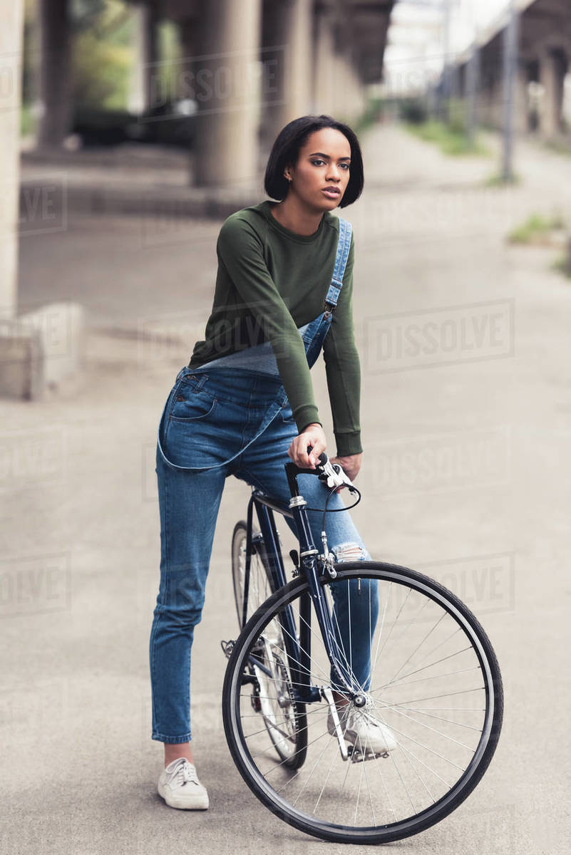 Young African American woman riding vintage bicycle - Royalty-free ...