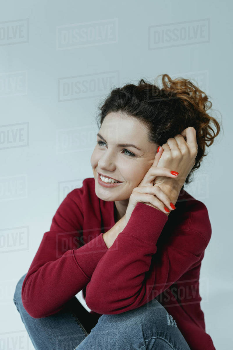 cheerful pretty woman posing in photo studio, isolated on grey ...