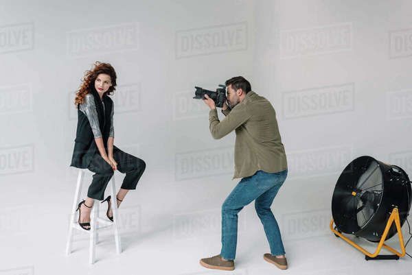 professional photographer and attractive model on fashion shoot in ...