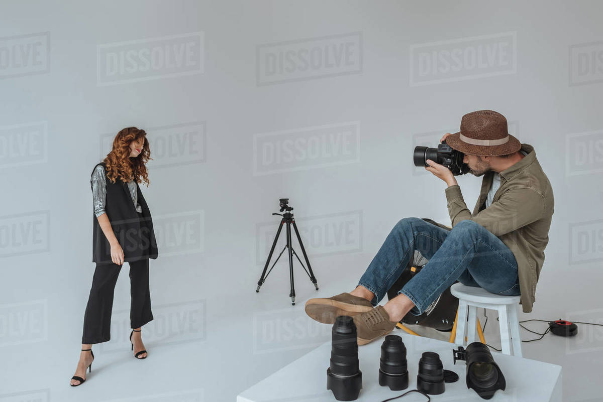 professional photographer and beautiful model on fashion shoot in photo ...