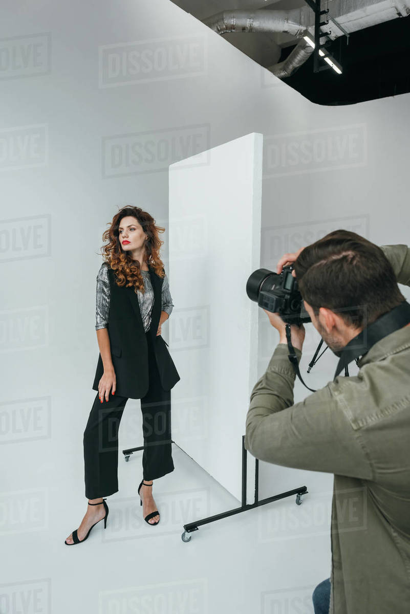 professional photographer and beautiful model on fashion shoot in photo ...