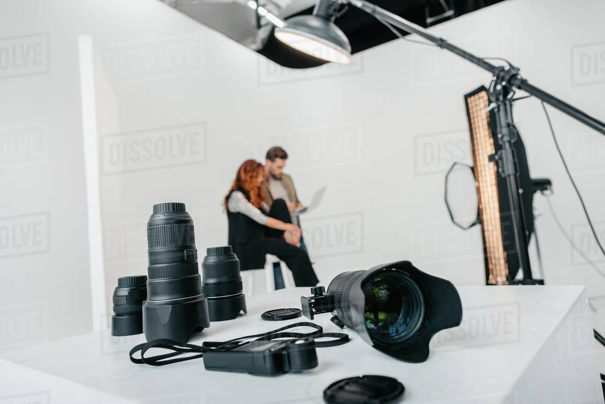 professional photographer and model with laptop in photo studio with ...