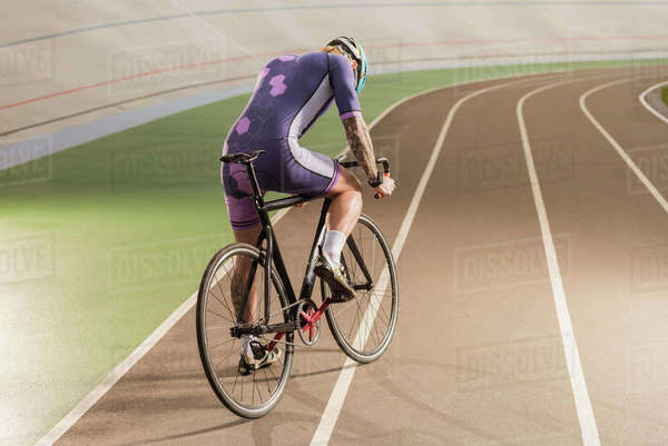 Back view of cyclist riding bicycle on cycle race track - Royalty-free ...