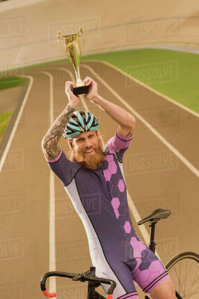 Portrait of smiling cyclist with champion cup looking at camera - Stock ...