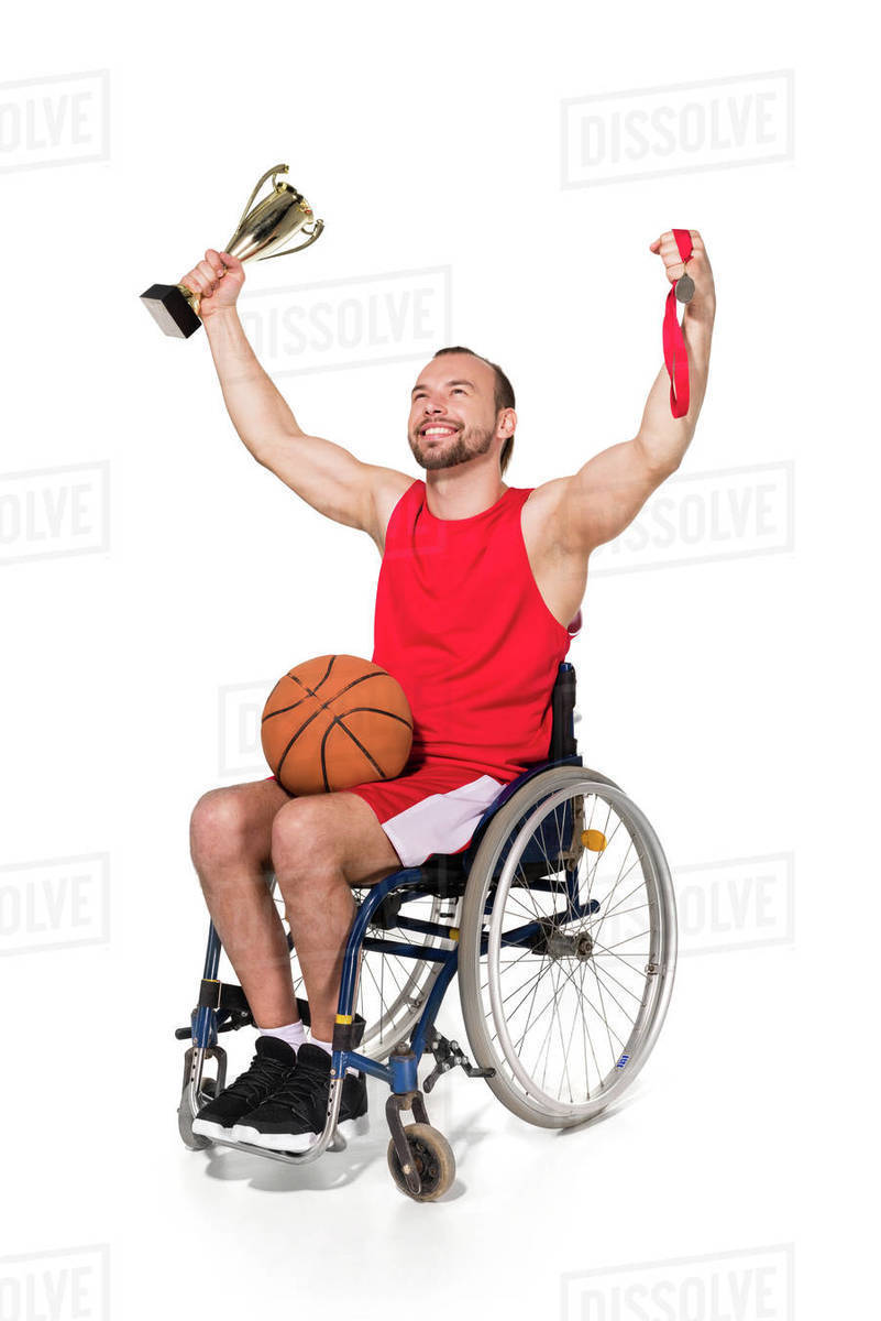 Disabled basketball player in wheelchair with champion goblet and gold ...