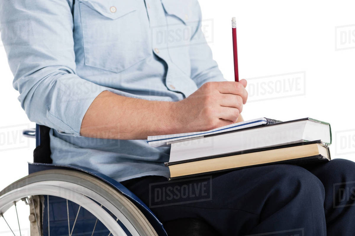 Cropped shot of physically handicapped man on wheelchair with books and ...
