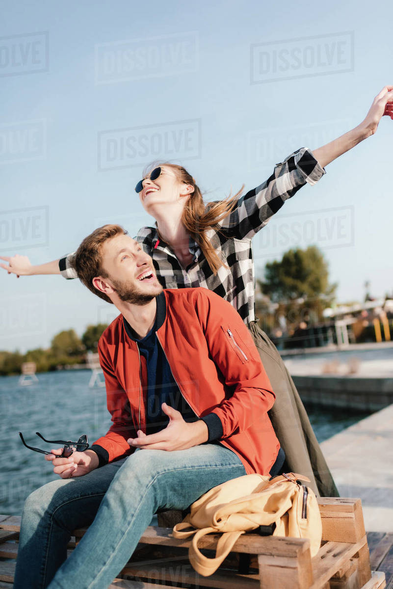 Portrait of happy couple spending time together on pier - Royalty-free ...