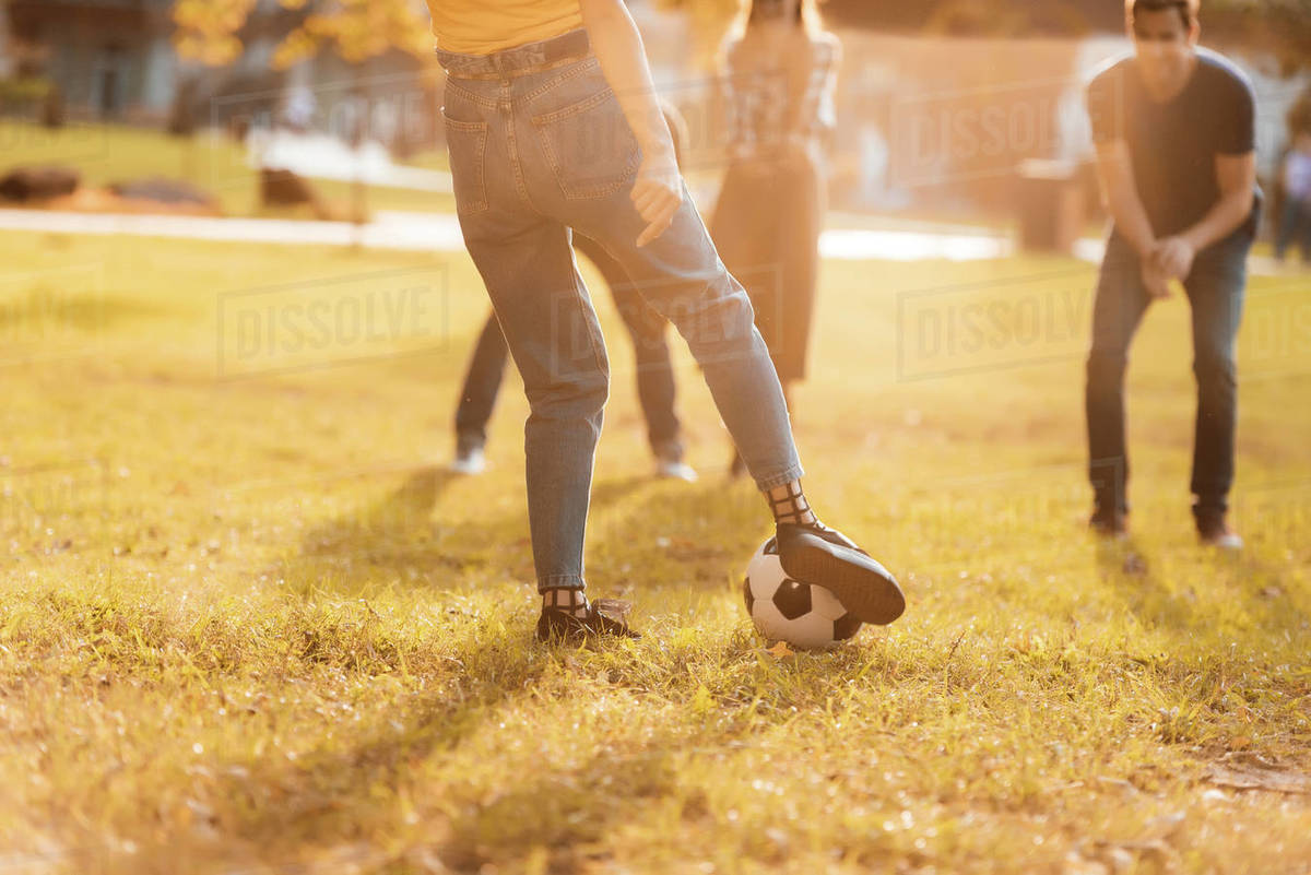 Selective focus of friends playing soccer together in park - Royalty ...