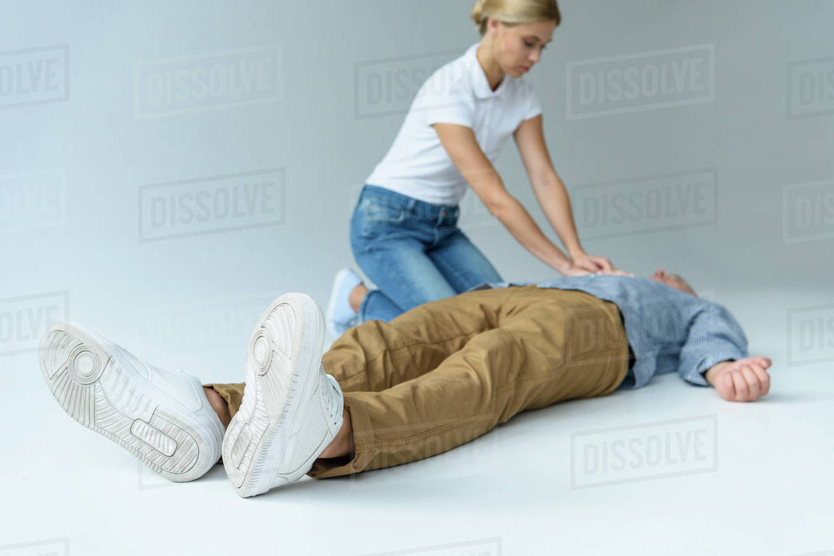 Beautiful woman on first aid training, isolated on grey - Royalty-free ...