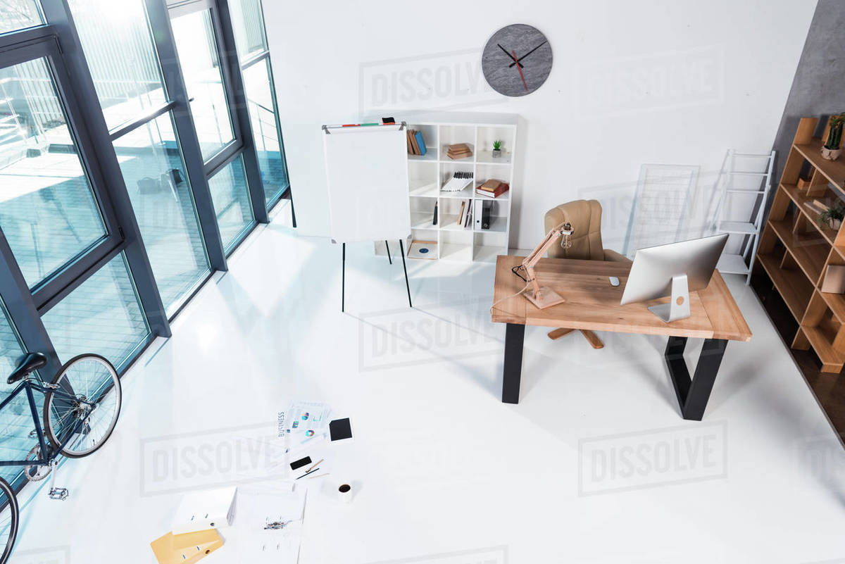 High angle view of modern office interior with documents and digital ...