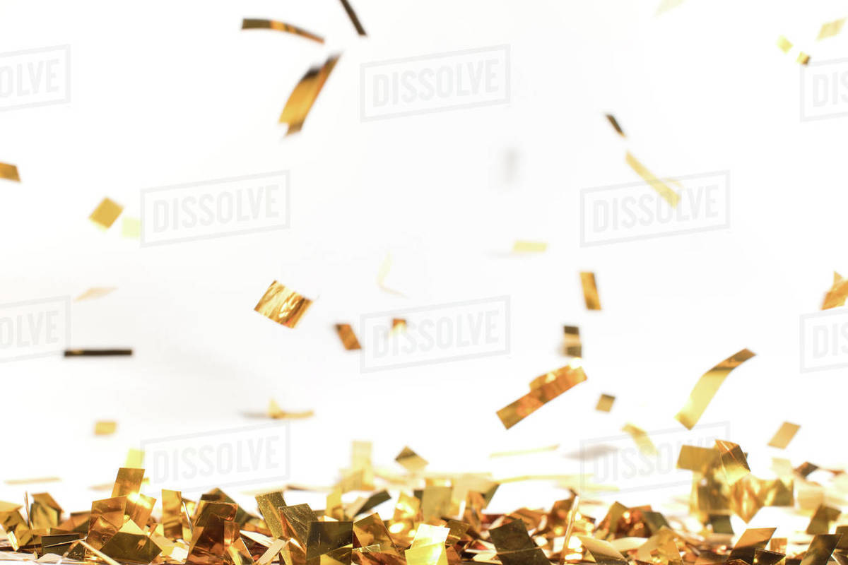 falling pieces of golden confetti on white - Royalty-free Stock Photo ...