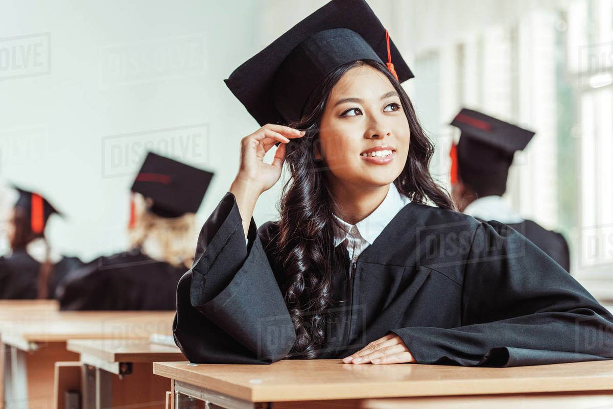 asian student girl in graduation costume sitting at classroom - Royalty ...
