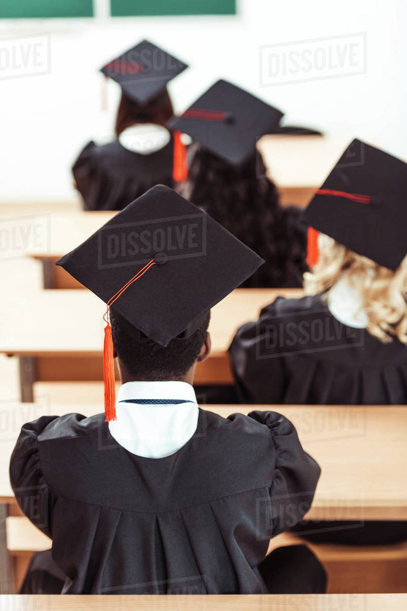 group of students in graduation hats sitting in class - Royalty-free ...