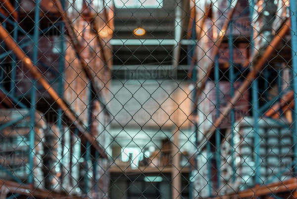 Close-up view of iron grid and blurred storage interior - Stock Photo ...