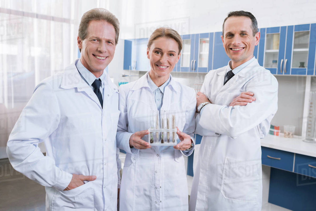 Team of professional scientists in white coats standing together ...