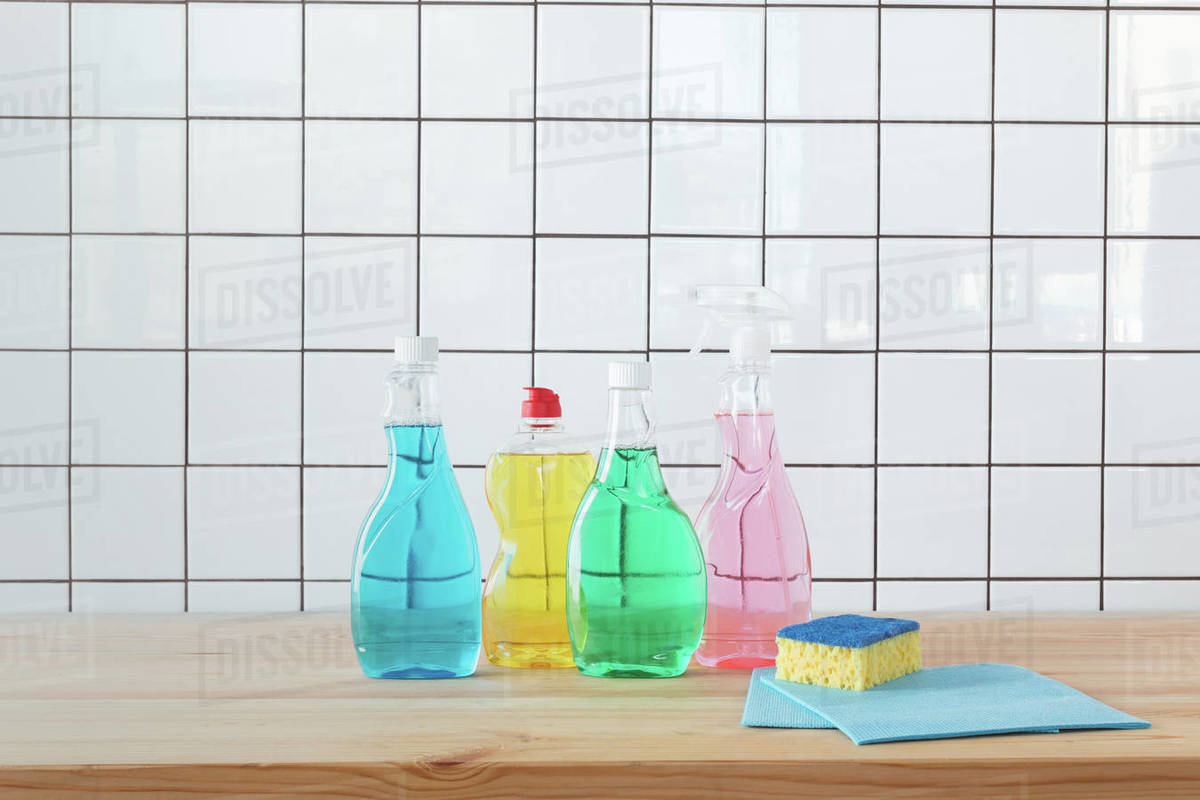 Close-up view of plastic bottles with colorful cleaning products ...