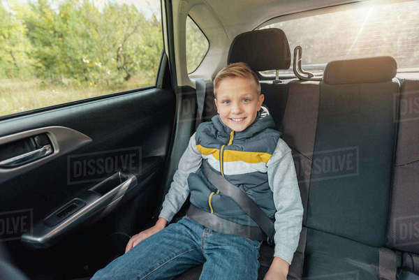 Happy little boy sitting in car and smiling at camera - Royalty-free ...
