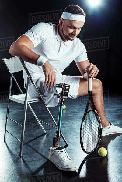 Tennis player with tennis racket resting on chair - Royalty-free Stock ...
