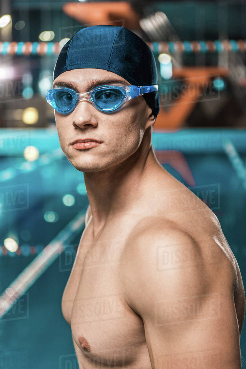Handsome muscular swimmer in swimming cap and goggles - Royalty-free ...