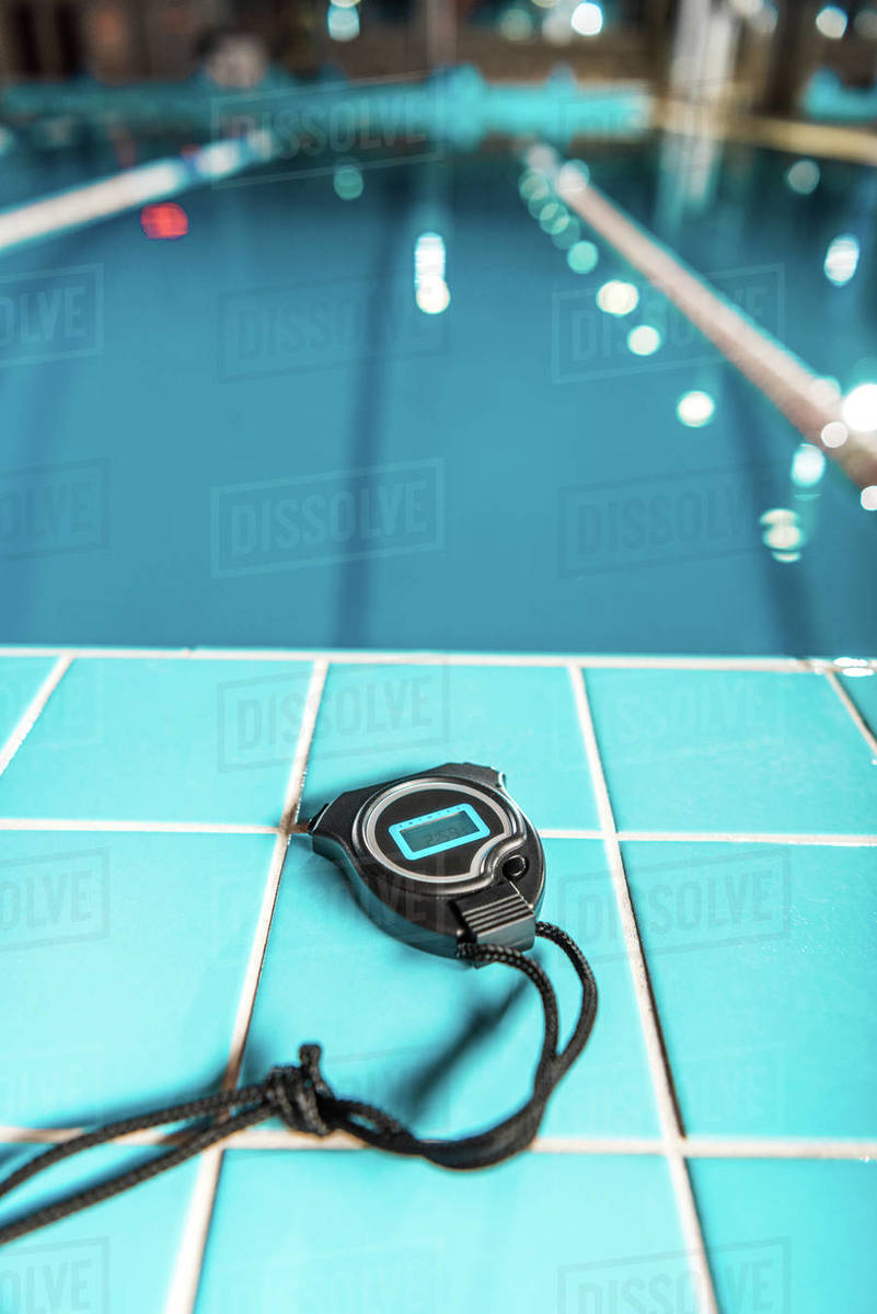 Stopwatch lying at competition swimming pool - Stock Photo - Dissolve