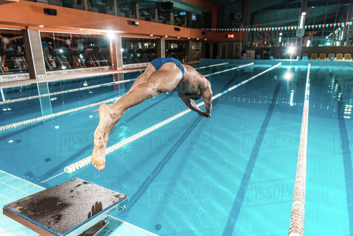 Swimmer diving into competition swimming pool - Stock Photo - Dissolve