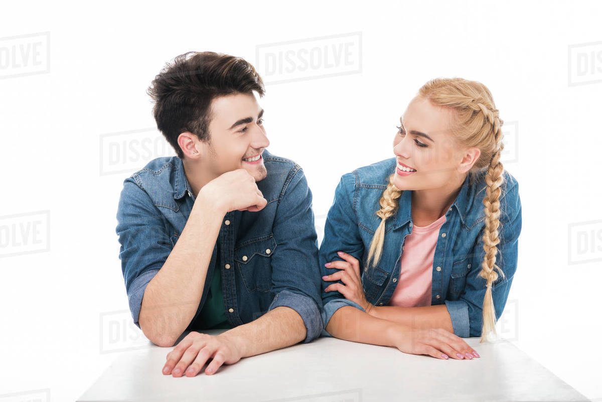 Happy young couple smiling each other isolated on white - Royalty-free ...