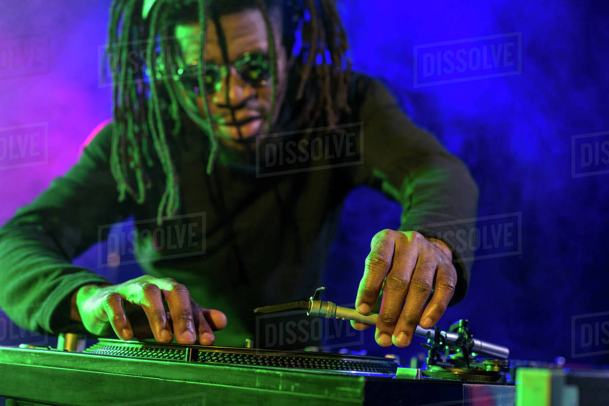 Professional African American dj with sound mixer in nightclub ...