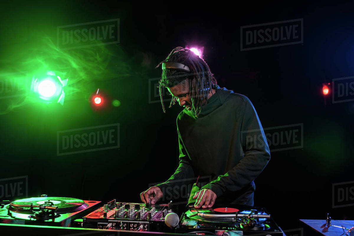 Professional African American club dj in headphones with sound mixer in ...