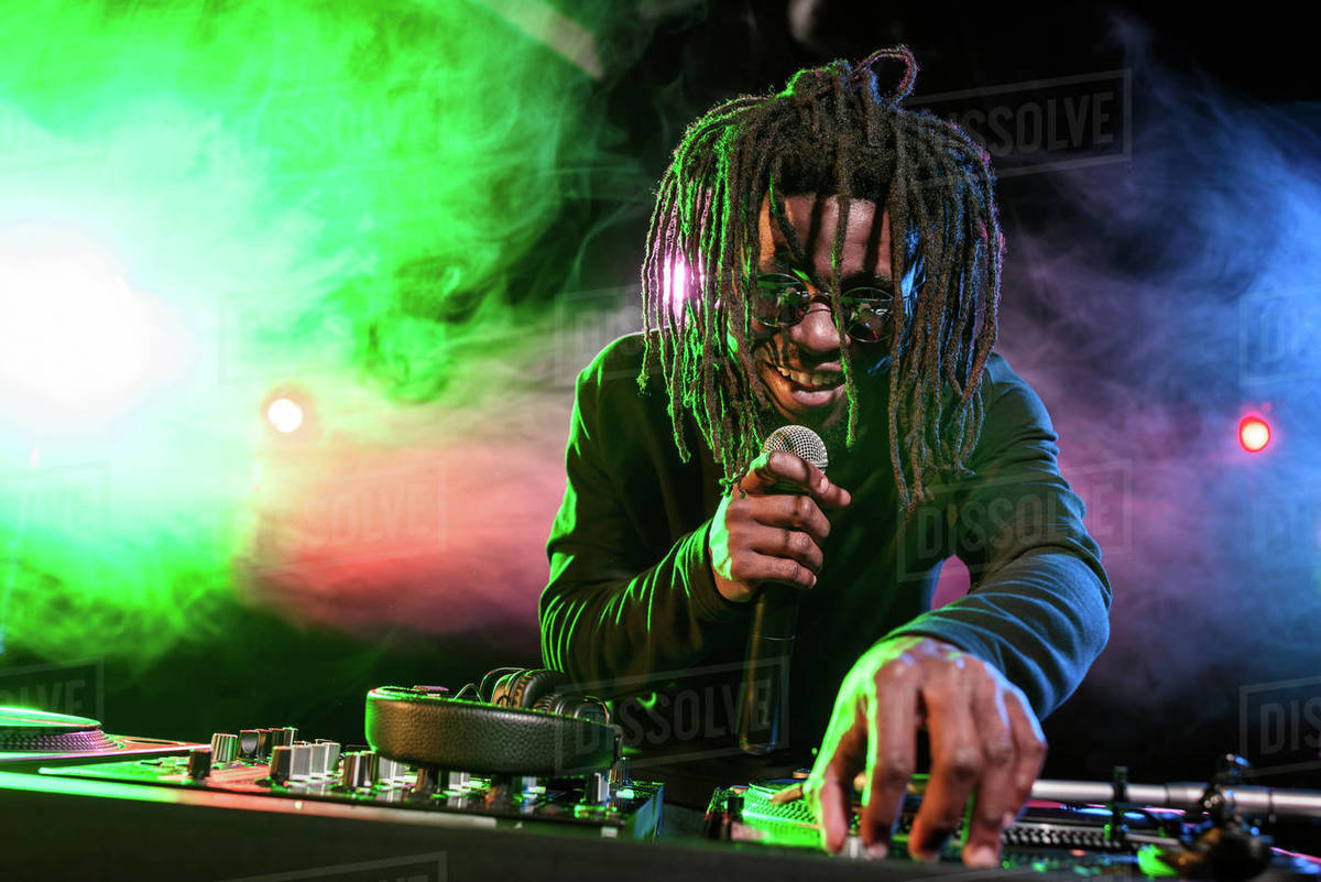 Professional African American club dj with microphone and sound mixer ...