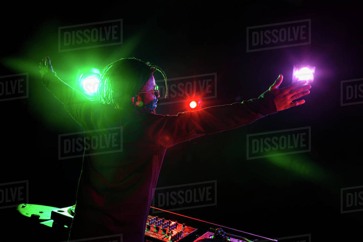 Professional African American club dj with sound mixer in nightclub ...