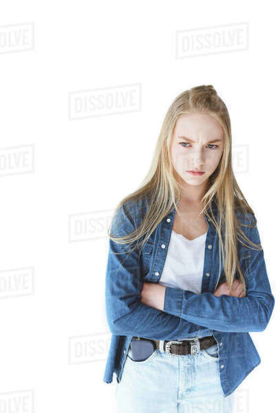 Grumpy teenage girl with arms crossed looking away isolated on white ...