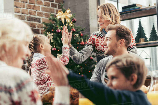Beautiful family giving high five while celebrating Christmas - Stock ...