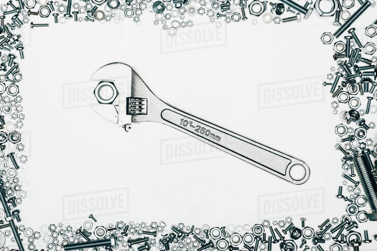 top view of arranged various metal engineering details with wrench in ...