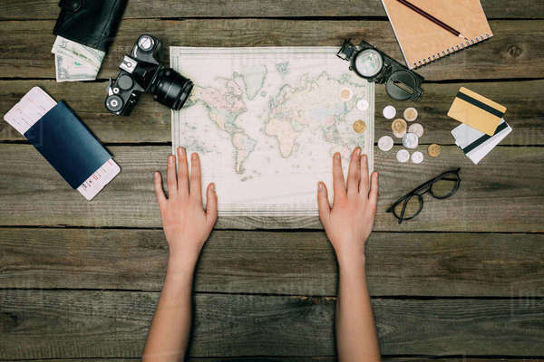 Top view of traveler hands on a map on a wooden table - Stock Photo ...