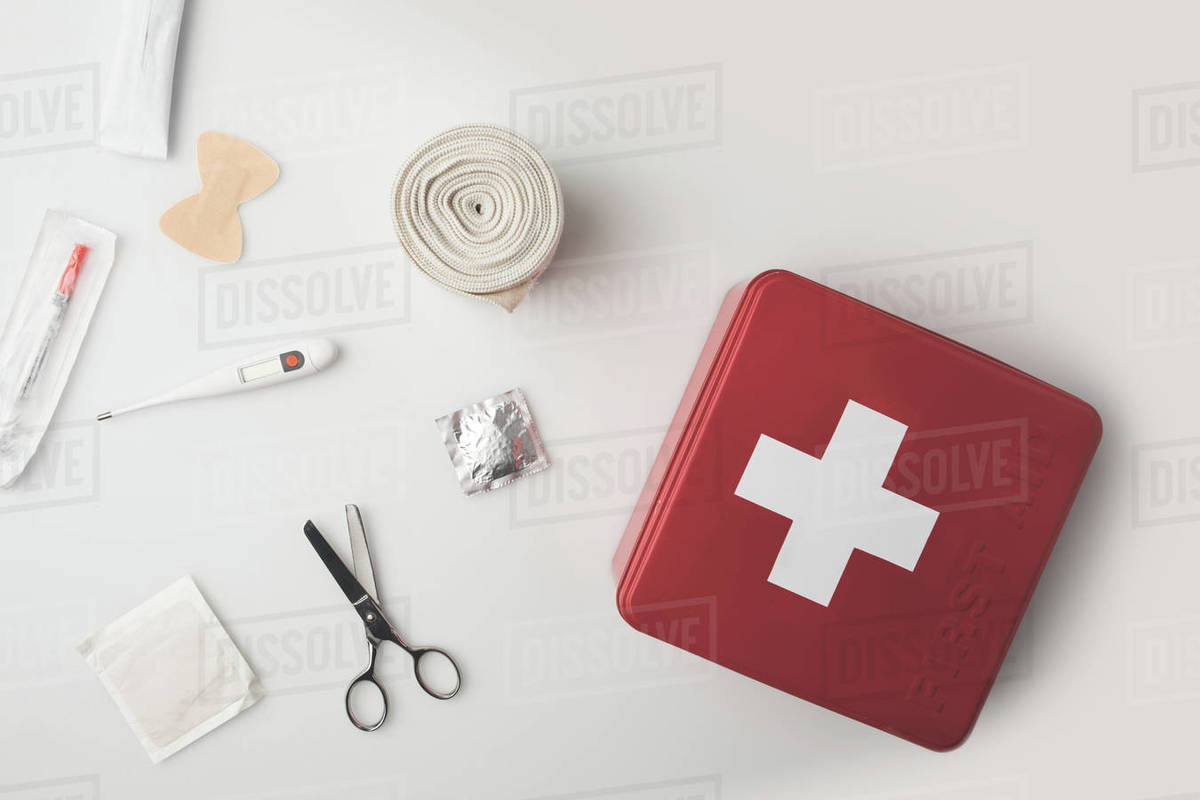 Top view first-aid kit with medical supplies isolated on white ...