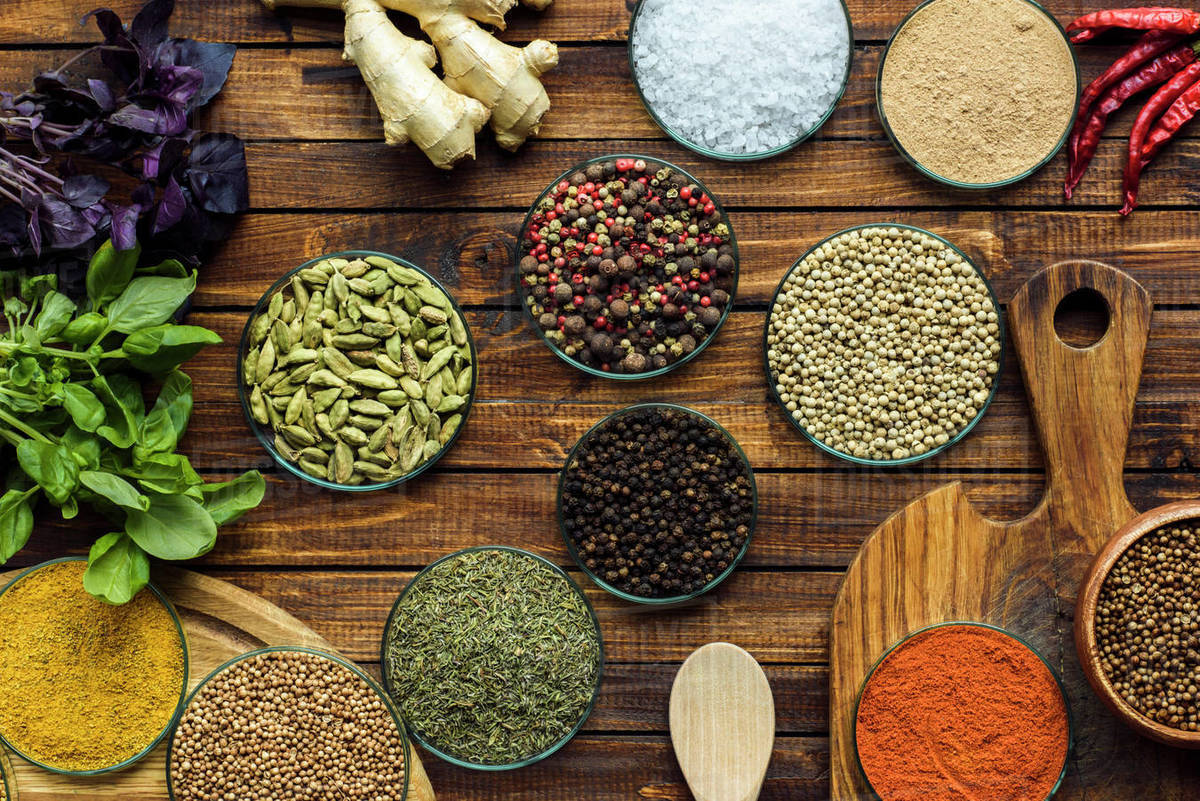 Top view of various spices on a wooden brown surface - Stock Photo ...