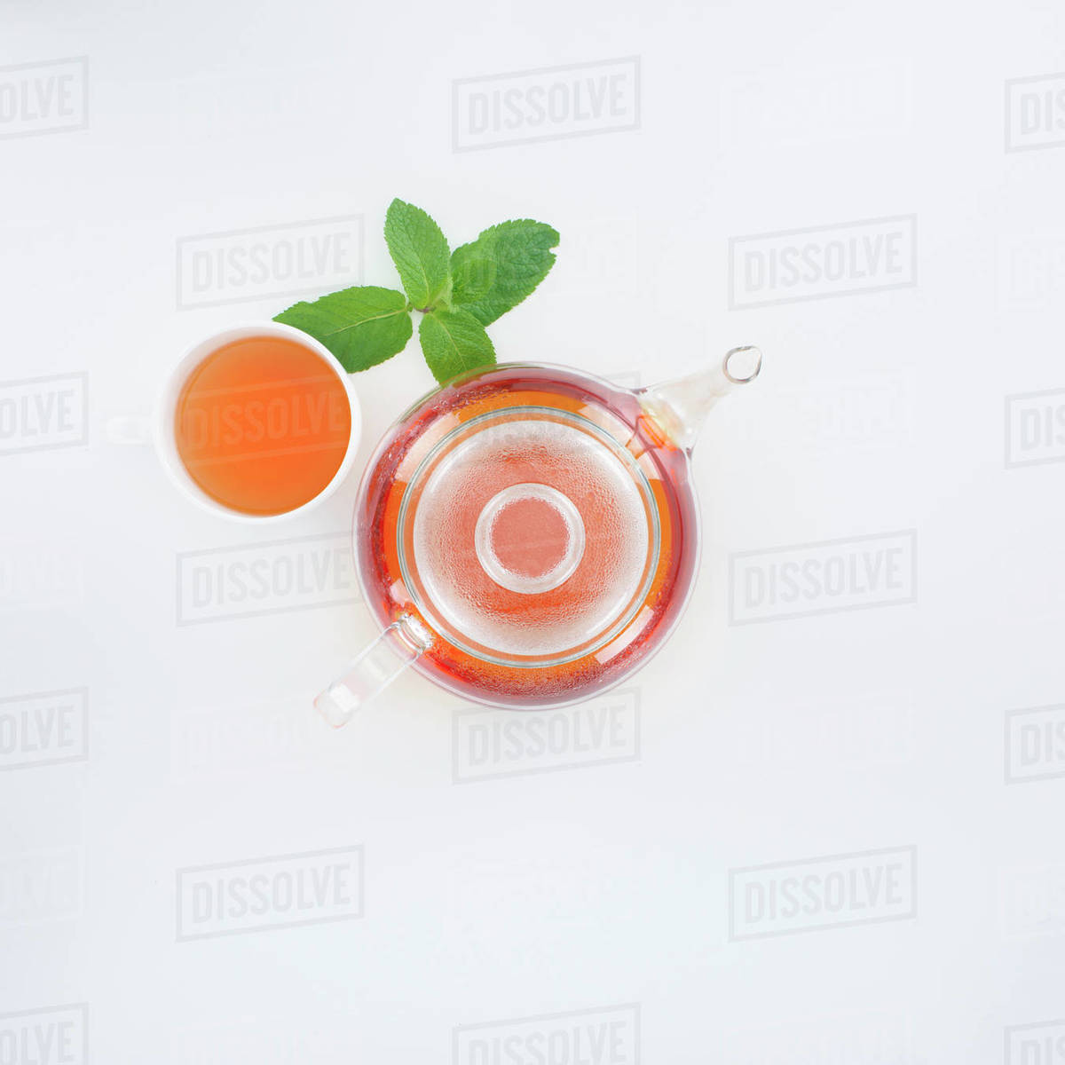 Top view of herbal tea in cup and kettle with peppermint isolated on ...