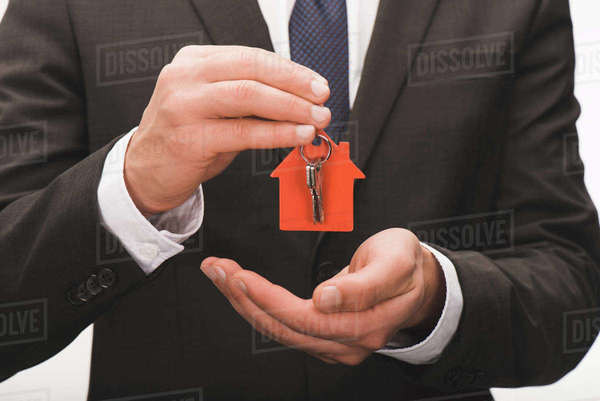 cropped image of man holding key from house isolated on white - Royalty ...