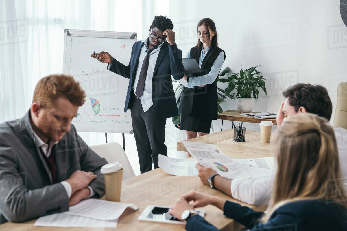 exhausted zombie like businesspeople having conversation at office ...