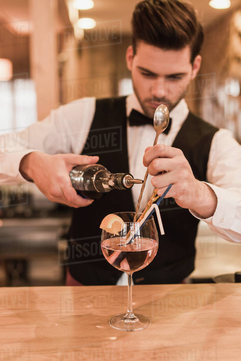 Bartender making alcohol cocktail at bar counter - Royalty-free Stock ...
