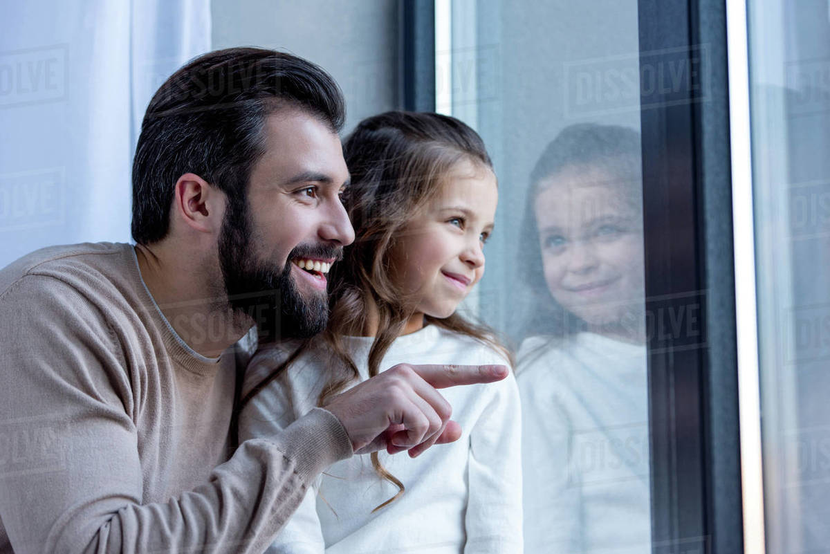 Happy father pointing on something and looking away - Royalty-free ...