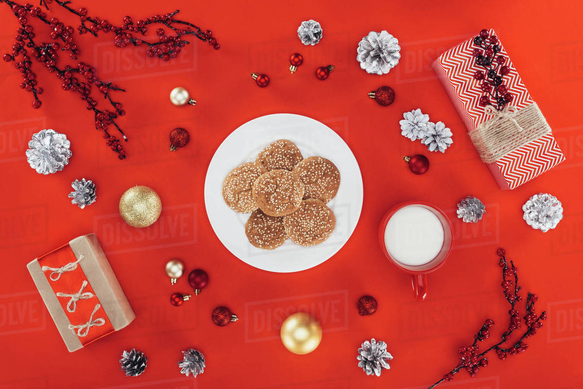 Flat lay with homemade oatmeal cookies on plate and cup of milk ...