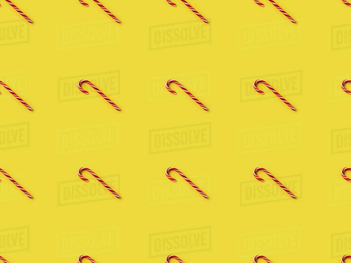 Set of candy canes isolated on yellow - Stock Photo - Dissolve