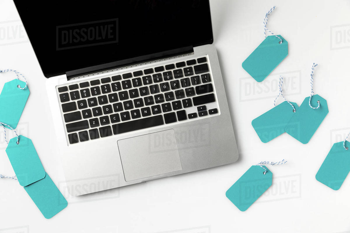 Close-up view of laptop with black screen and blank blue labels on ...
