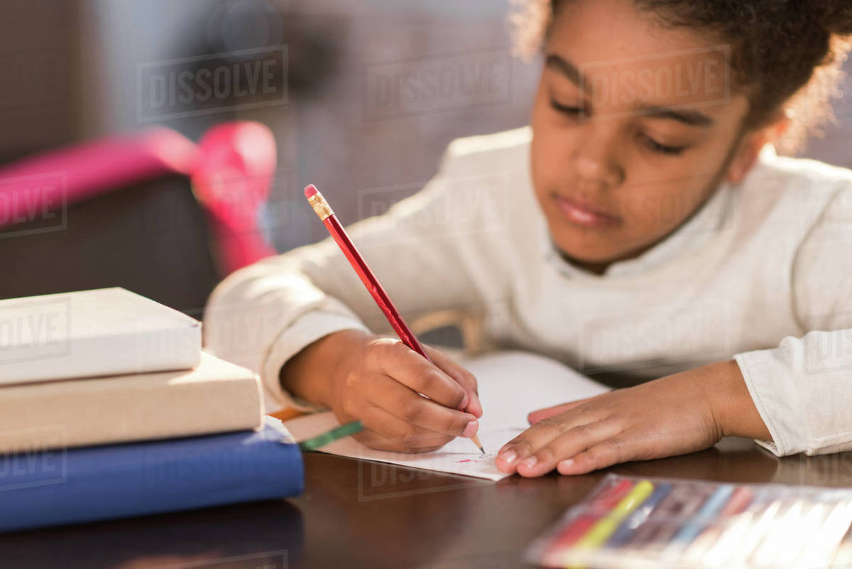 African american schoolgirl doing homework, elementary school student ...