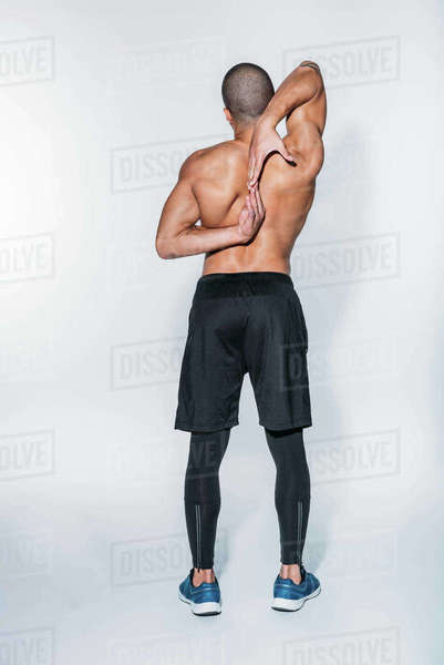 rear view of african american sportsman stretching back - Royalty-free ...