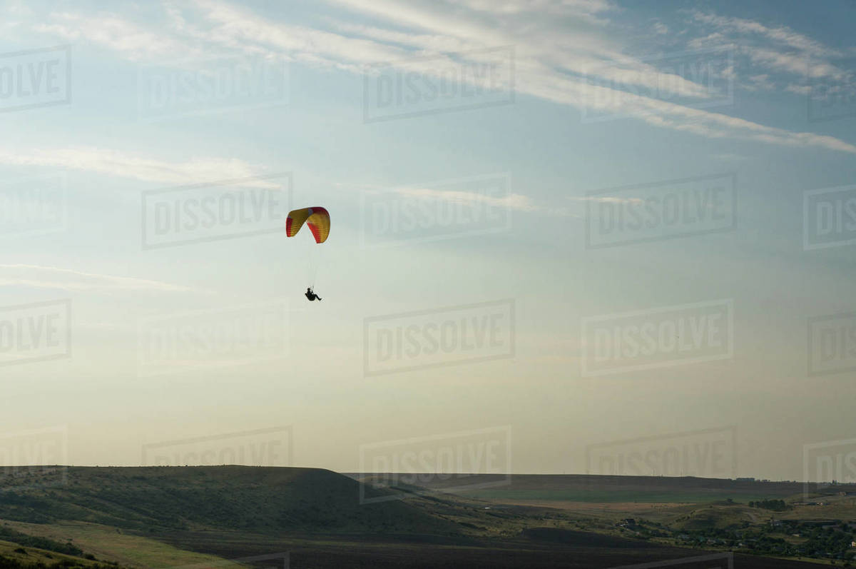 person flying on paraplane sky with clouds on background - Stock Photo ...