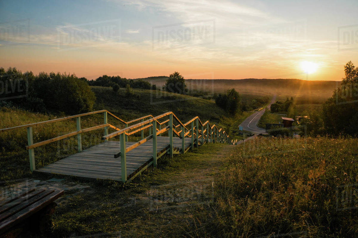 Wooden stairs to the road at beautiful sunset - Royalty-free Stock ...